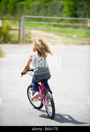 Young girl riding bicycle wind in hair Stock Photo: 21119284 - Alamy