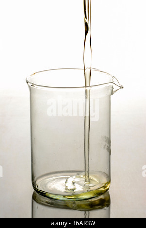 FILLING COCONUT OIL IN A BEAKER Stock Photo - Alamy