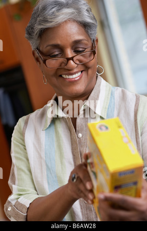 African woman reading food ingredients Stock Photo - Alamy