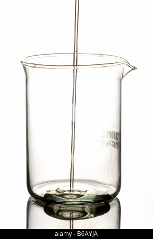 FILLING COCONUT OIL IN A BEAKER Stock Photo - Alamy