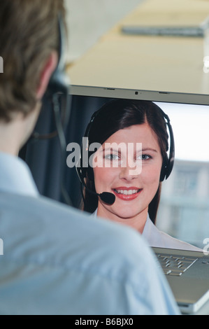 Portrait of a male customer service representative talking on a headset ...