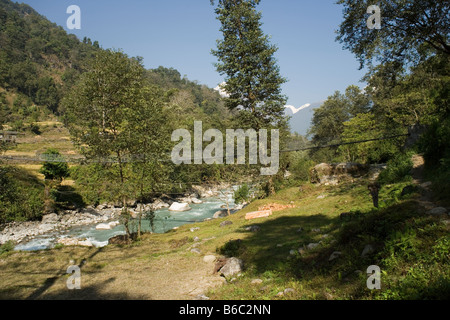 Metal rope bridge crossing the Modi river valley in the Annapurna range ...