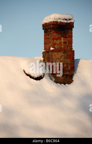 Chimney from red bricks on a snow covered roof Stock Photo - Alamy