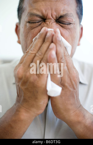 Senior man is sneezing into handkerchief Stock Photo - Alamy