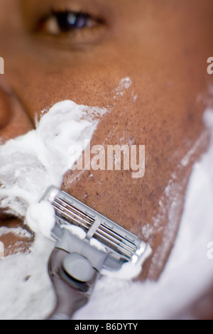 Man shaving with razor using foam in bathroom in the morning Stock ...