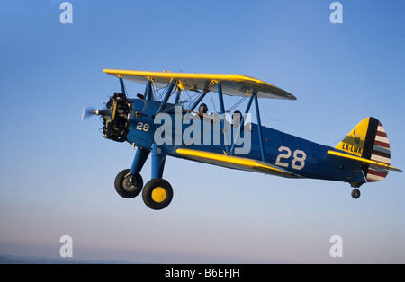 An aerial view of a WWII Boeing Stearman biplane pilot trainer in black ...