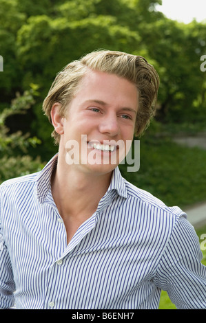 Positive man in striped t-shirt smiling and taking selfie photo ...