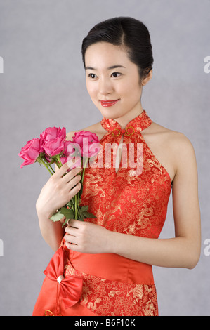beauty woman wear red cheongsam looking and smile in chinese new year ...