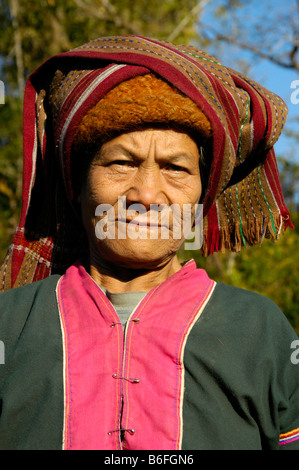 Burmese woman wearing a traditional head covering and smoking a ...