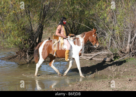 A Native American Indian man riding bareback on a horse in the Stock ...
