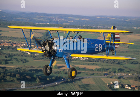 An aerial view of a WWII Boeing Stearman biplane pilot trainer in black ...