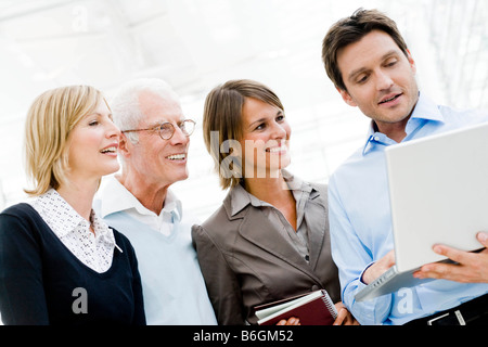 Business people looking at laptop Stock Photo - Alamy