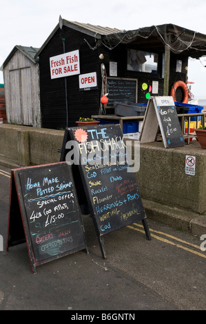 Signs outside a fish sellers stall on the seafront at Aldeburgh Stock ...