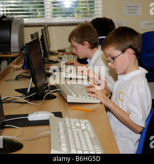 Pupils working at their desks in class Stock Photo - Alamy