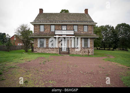 An 18th century colonial American farmstead with various out buildings ...