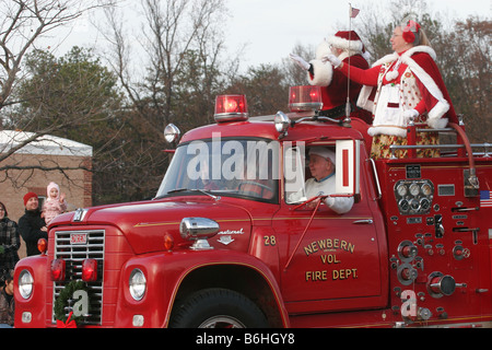 Santa Claus and Mrs Claus ride in on an antique 1960 fire truck at a ...