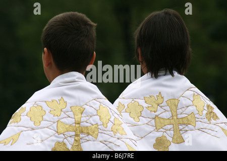 two roman catholic altar boys during sunday service in a church in ...