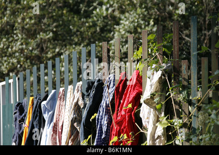 homeless immigrant clothes on washing line fence in rome, italy Stock ...