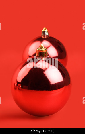 Arrangement of two red Christmas baubles on white fur Stock Photo - Alamy
