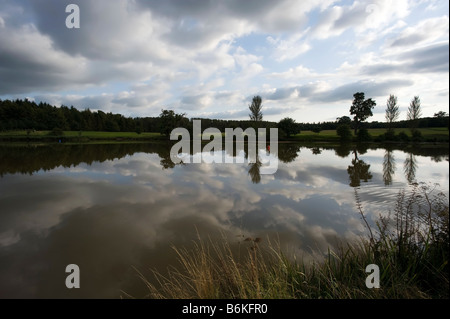 cumulo nimbus clouds at sunset reflected in a lake Stock Photo - Alamy