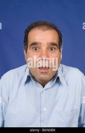 Shocked mature man in front of a vehicle with broken windscreen ...