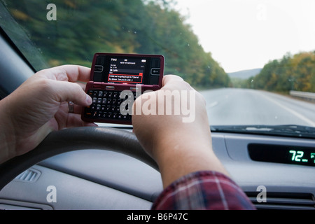 Josh Fiedler of Royalton Vermont text messages his wife as he drives ...