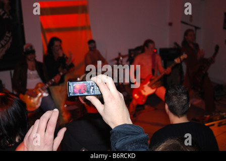 spectator taking snapshot at rock concert with digital camera Stock ...