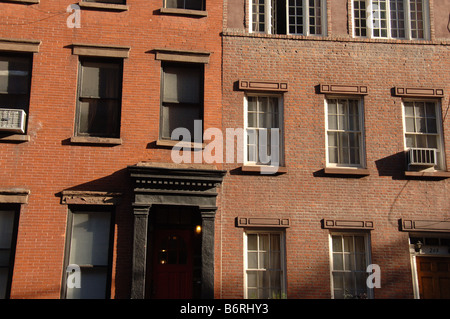 Tenement apartment buildings in New York City during winter snowstorm ...