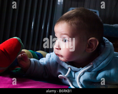 baby curios on the ground lying Stock Photo - Alamy