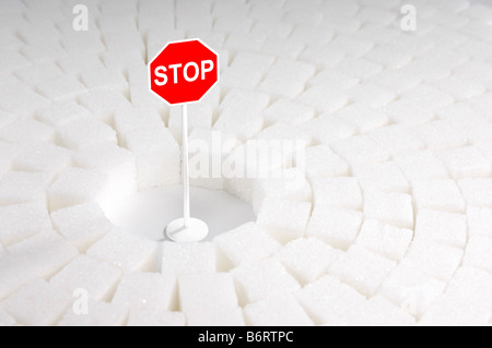 Sugar cubes with red stop sign on blue background, sugar addiction ...