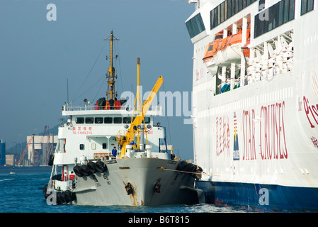 Small tanker delivering fuel to a cruise ship Stock Photo - Alamy