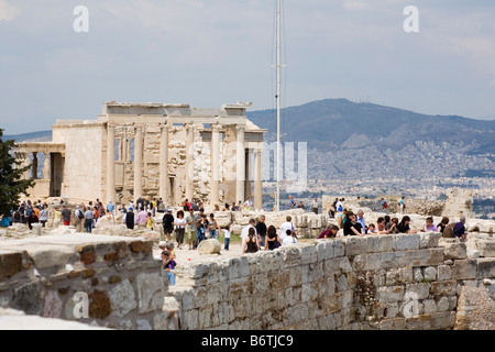 A crowd of tourists around the Acropolis of Athens Unesco heritage with ...