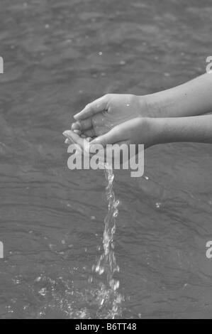 Water passing through a childs hands at beach Stock Photo - Alamy
