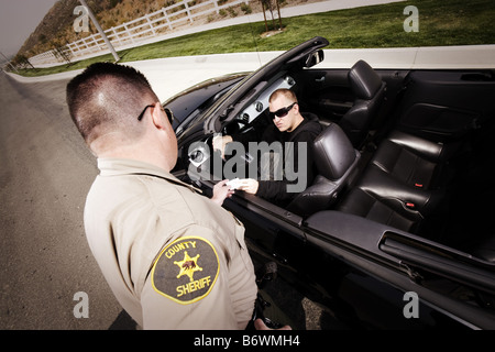 Man in Mustang handing police officer drivers license Stock Photo - Alamy