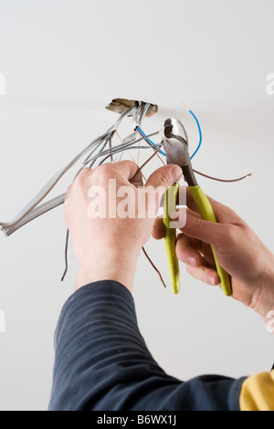 Man at home cutting wire with pliers. DIY repairs concept Stock Photo ...