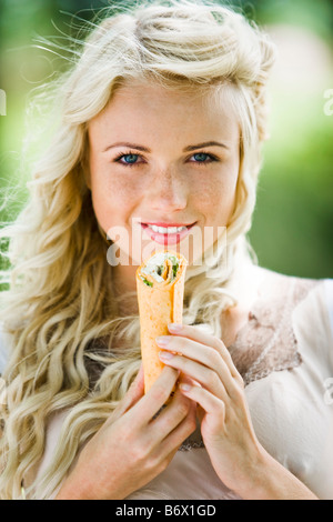 Young woman eating enchilada Stock Photo - Alamy