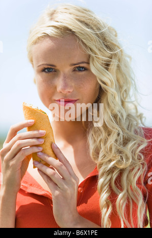 Young woman eating enchilada Stock Photo - Alamy