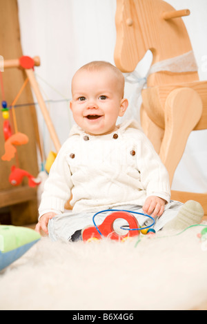 Baby boy playing with toys on the floor Stock Photo - Alamy