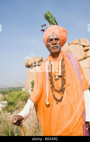 Portrait of a sadhu standing on one leg on the support of swing at Maha ...