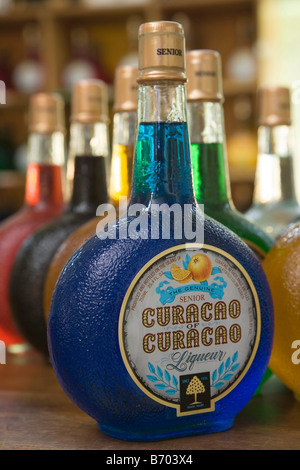 Bottles of Curacao liqueur liquor alcohol in the craft market ...