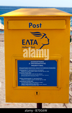 Greek yellow Hellenic Post post box on a pink wall Stock Photo - Alamy