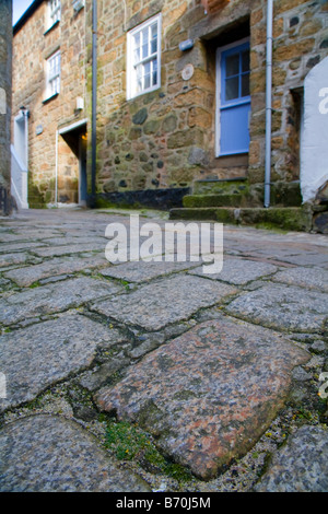 St Ives Cornwall cobbled street with white cottages and granite walls ...