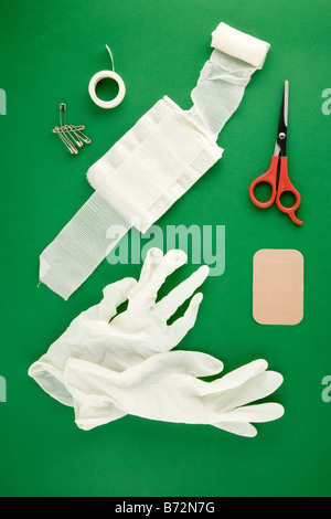 First aid kit, scissors, gloves, pills, plastic forceps and elastic ...