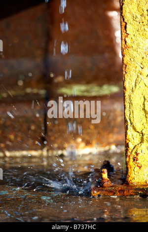 water dripping hitting concrete and making a splash county down ...