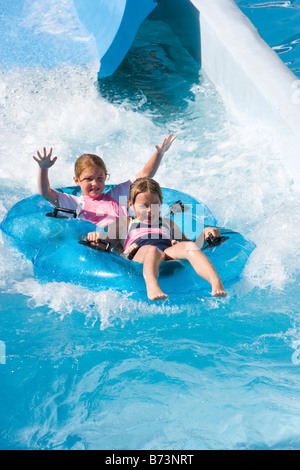 Children sliding down waterslide at waterpark Stock Photo - Alamy