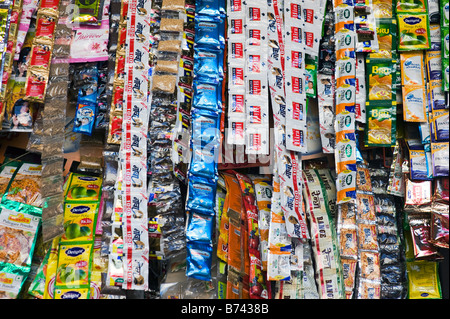 Single use sweet and consumer item packets hanging in an rural Indian ...