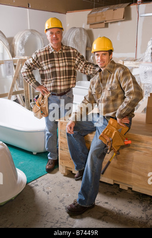 Father and son wearing hard hats on white background. Repair work Stock ...