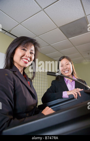 A woman in a suit standing at a lectern Stock Photo - Alamy