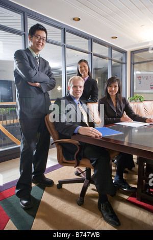 Diverse Asian business executives in a team discussion Stock Photo - Alamy