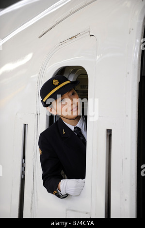 A female train guard on the Shinkansen bullet train at Tokyo Railway ...